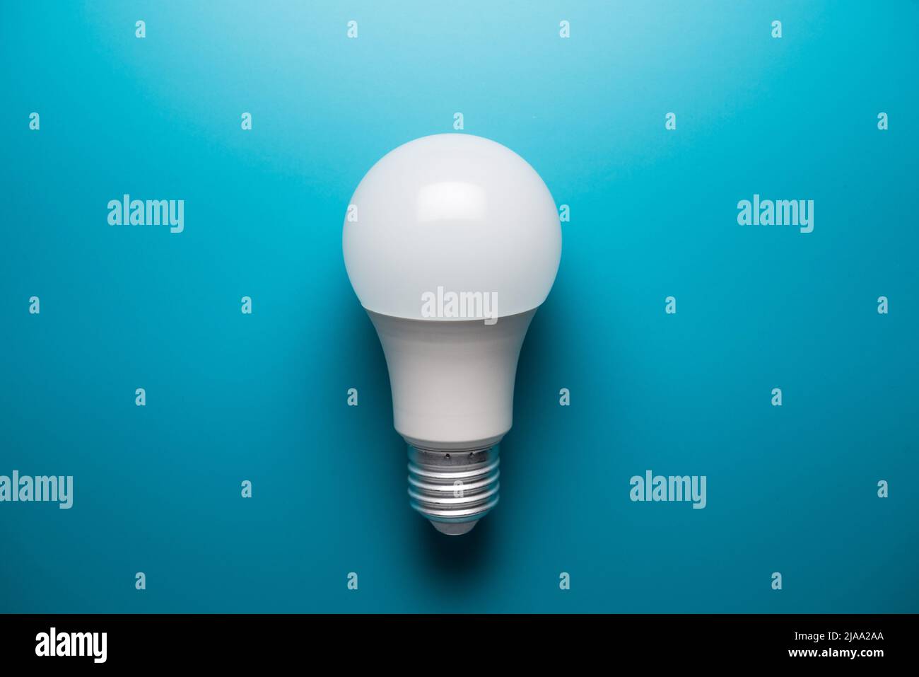 Modern energy efficient light bulb on blue background, conceptual image ...