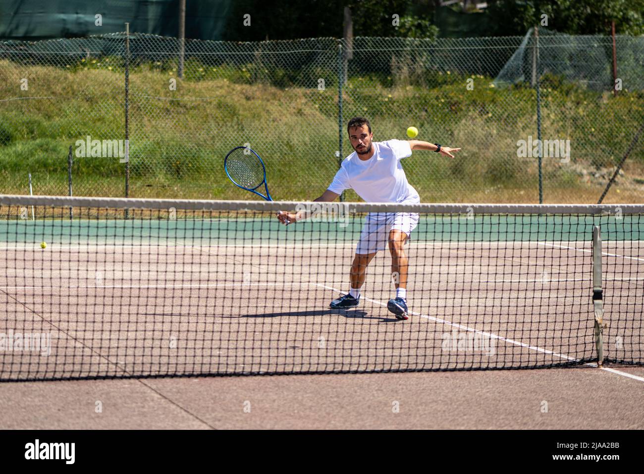 Tennis player performing a drop shot on court Stock Photo - Alamy