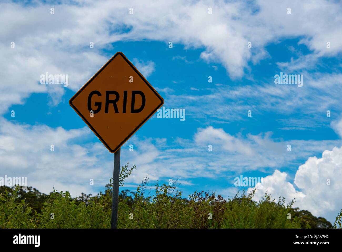 Grid road sign with blue cloudy sky Stock Photo - Alamy