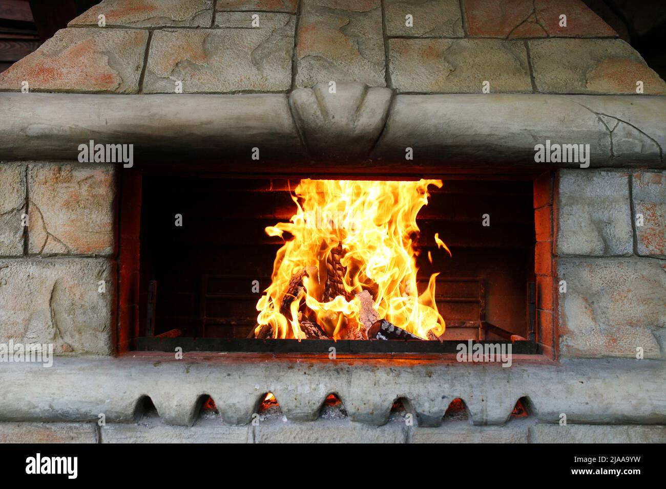 A warm fire in the stone fireplace on a cold night Stock Photo - Alamy