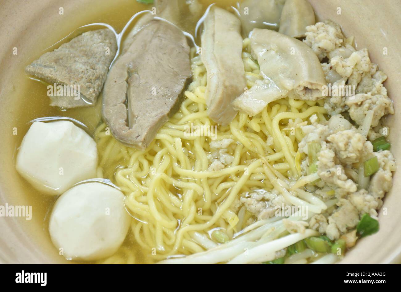 boiled Chinese yellow egg noodles with entrails and fish ball in soup ...