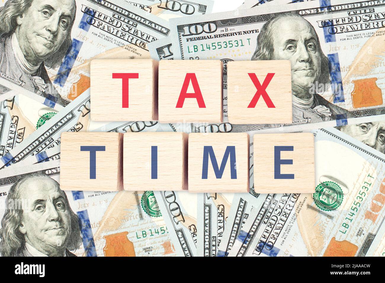 Tax time concept. Tax with pile of 100 us dollar banknotes background ...