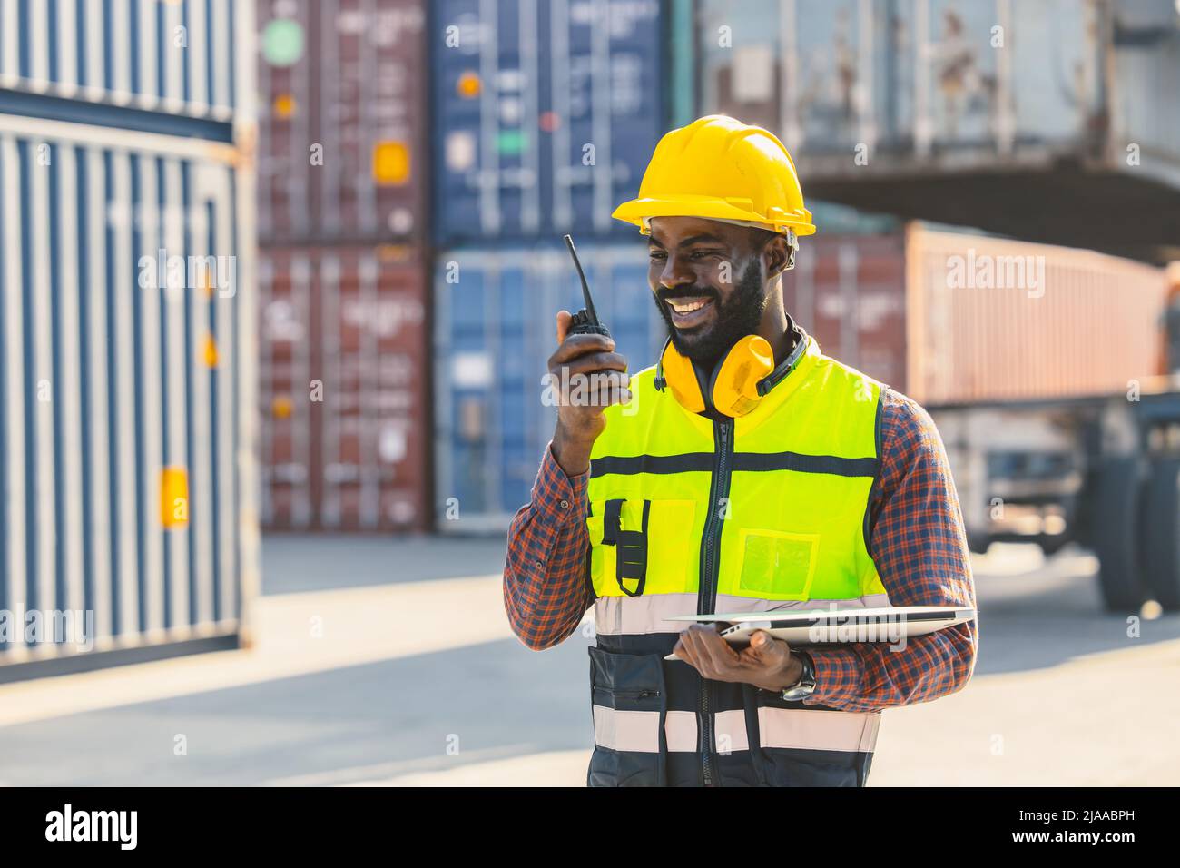 black worker African working engineer foreman radio control in port ...