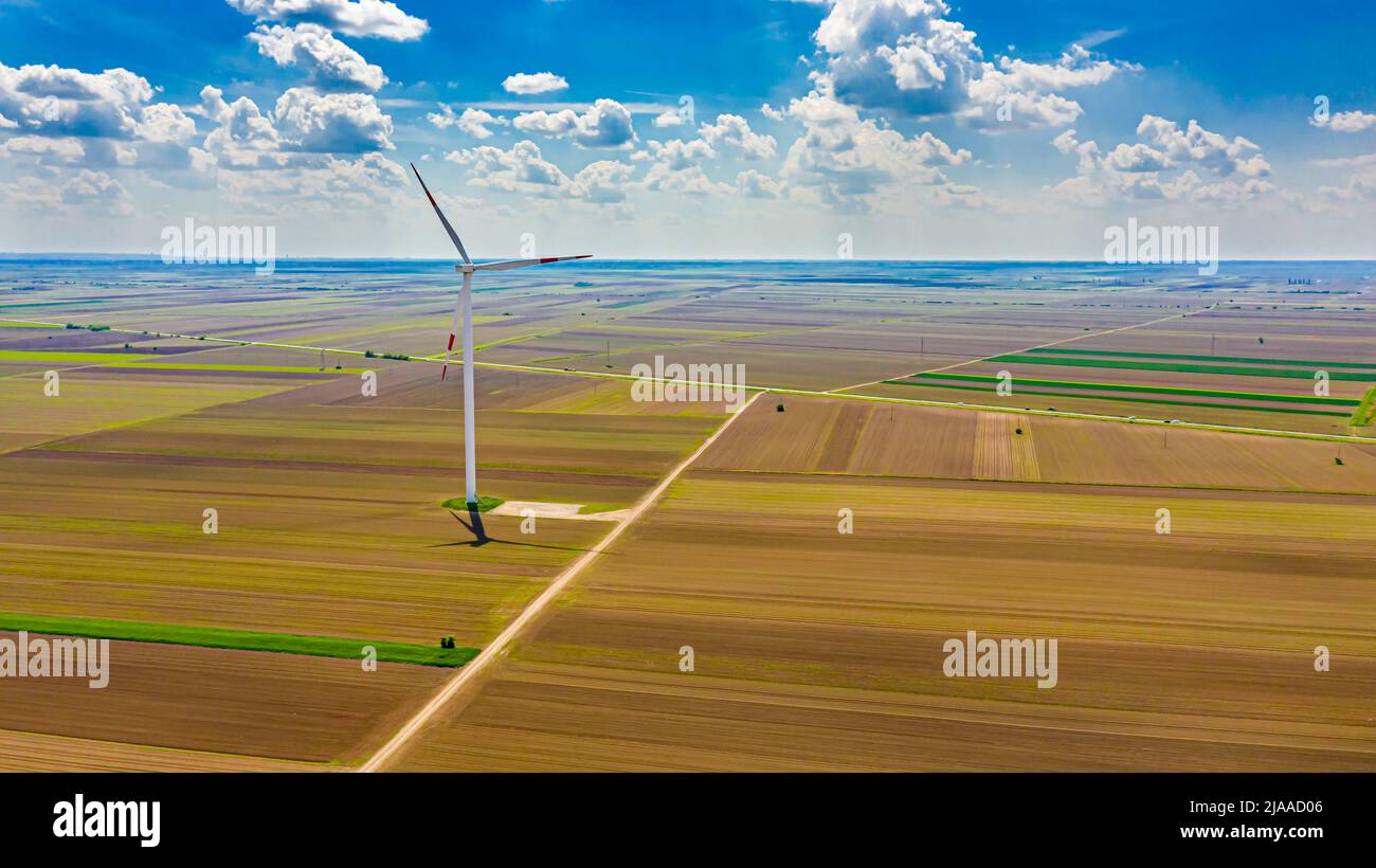 Above view on farm of large wind power turbines are standing among ...