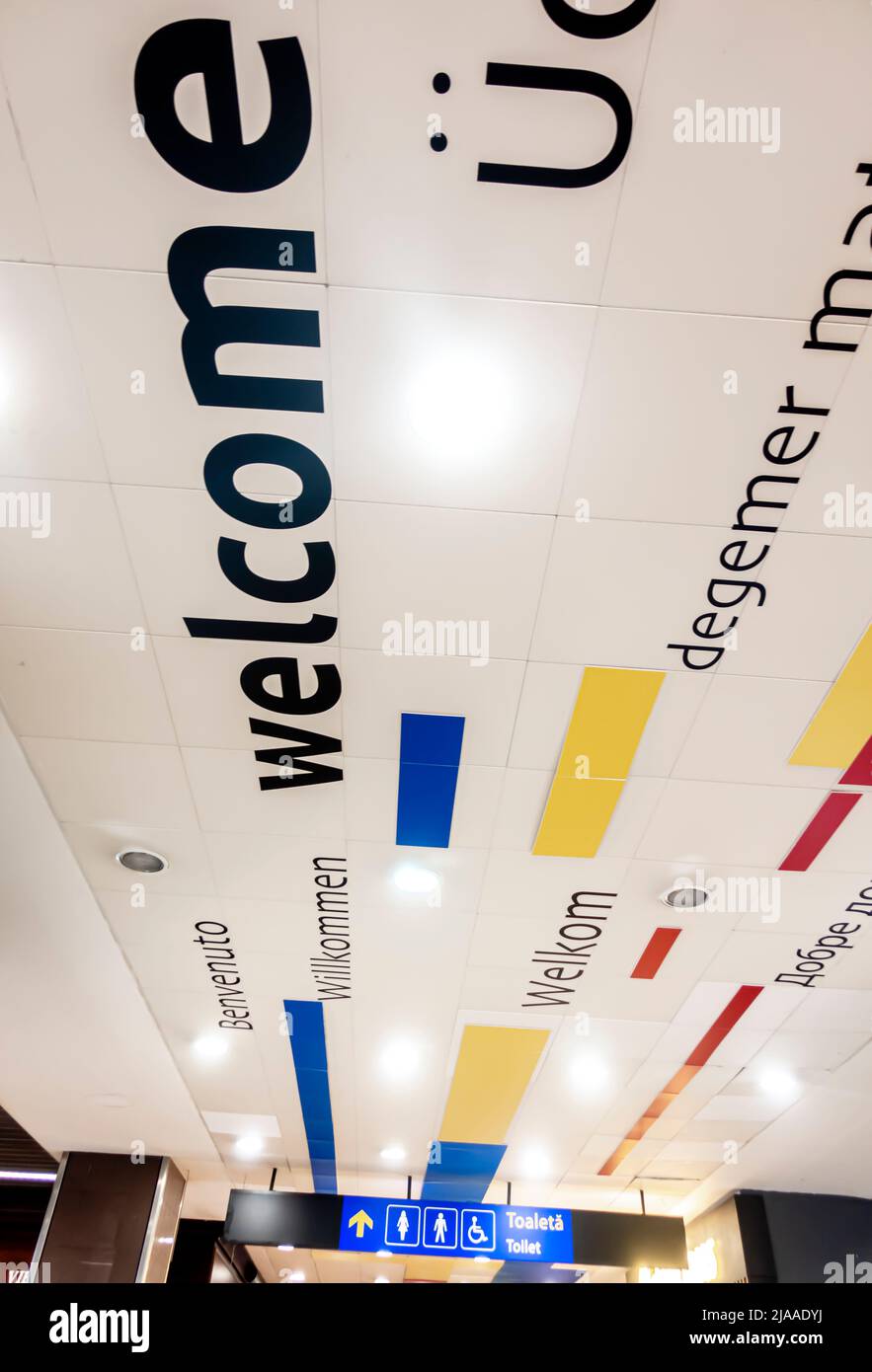 Welcome in many languages printed on a celing in the terminal of Henri ...