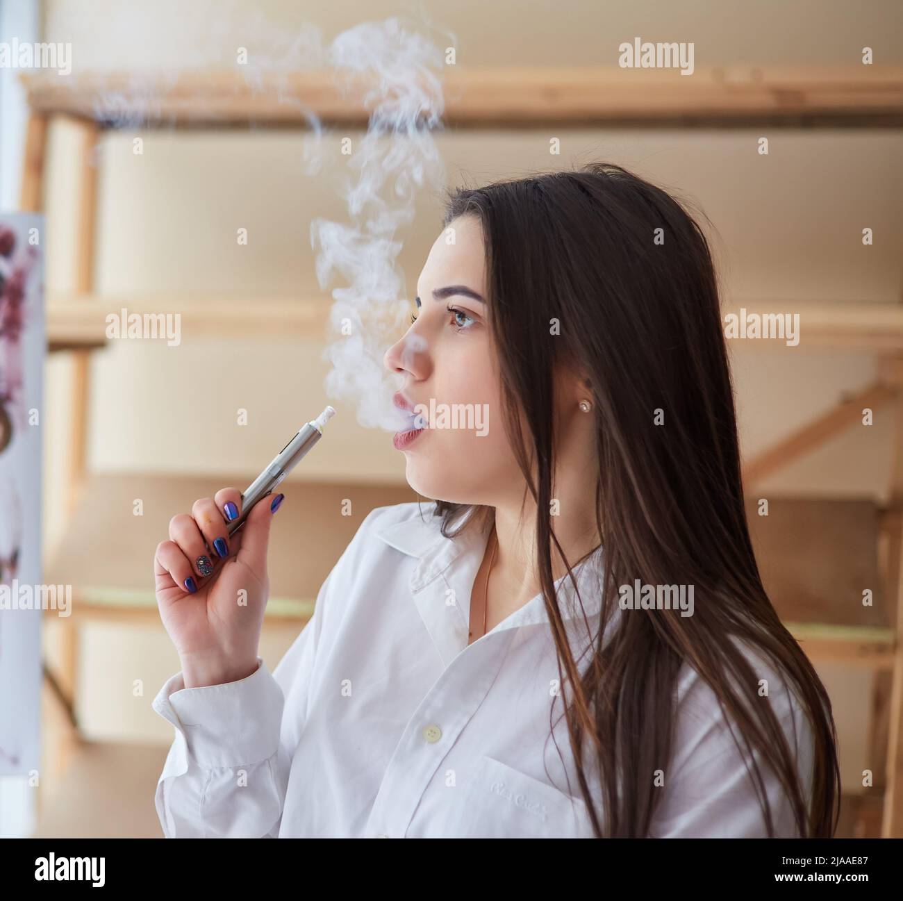 Happy vaper girl with vaping device in hand.Quit smoking nicotine ...