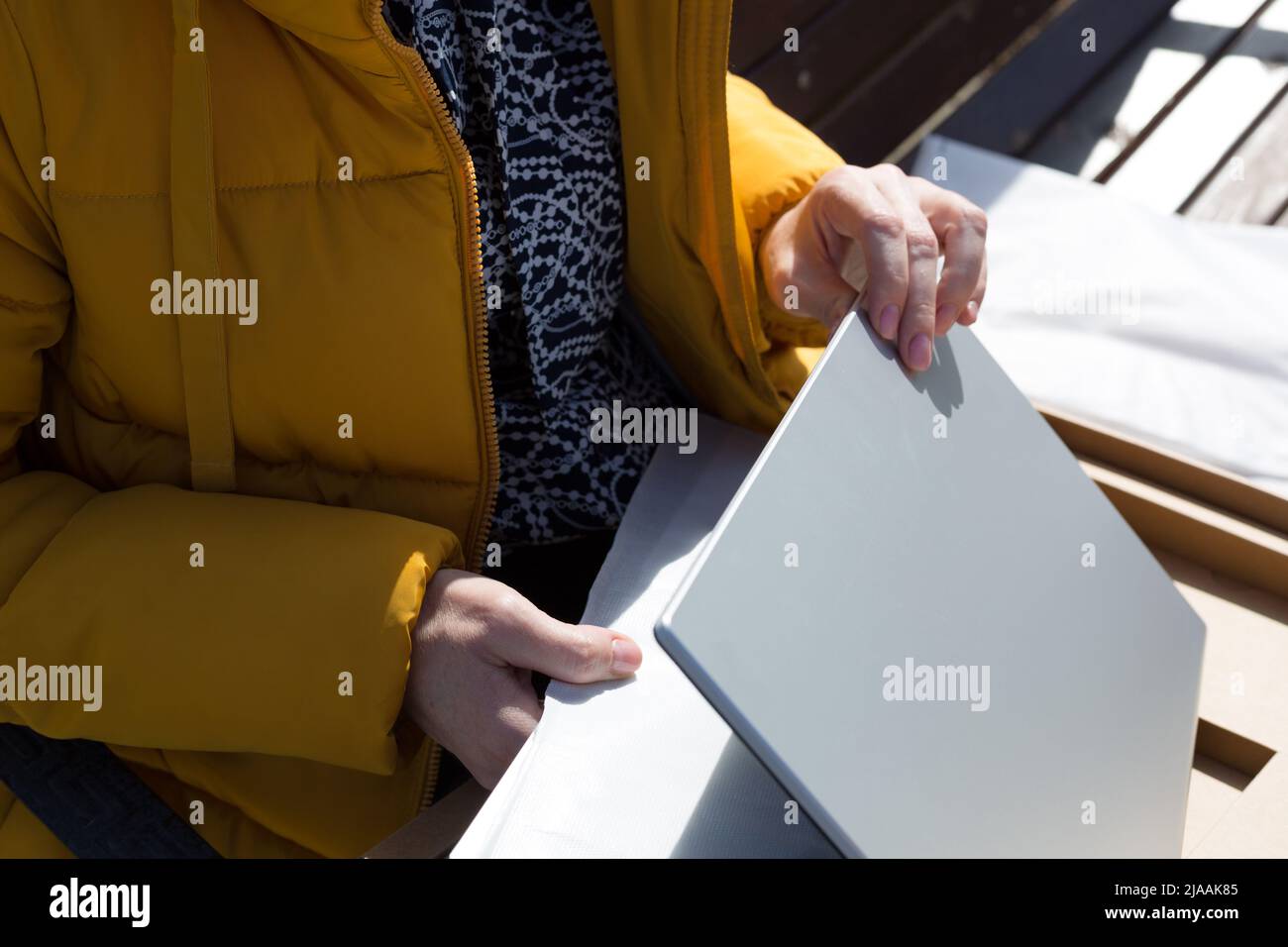 A woman inspects newly purchased laptop defects and defects Stock Photo ...