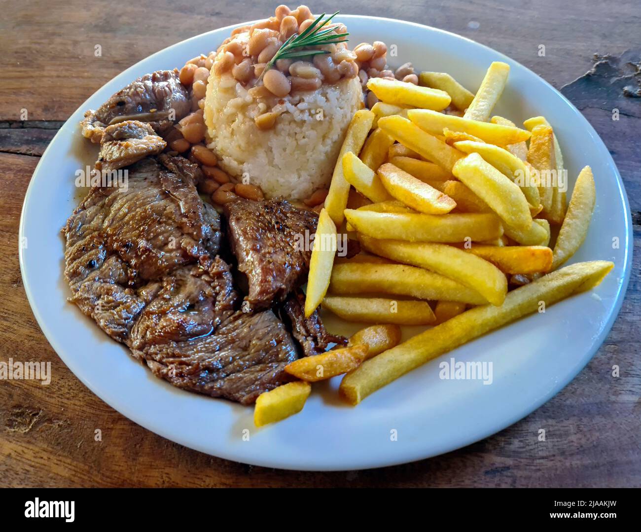 Dish made with rice, beans, french fries and meat Stock Photo - Alamy