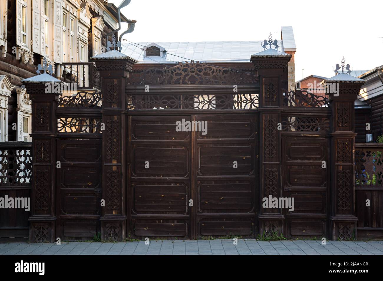 Wooden old high carved fence in the city center. The concept of ...