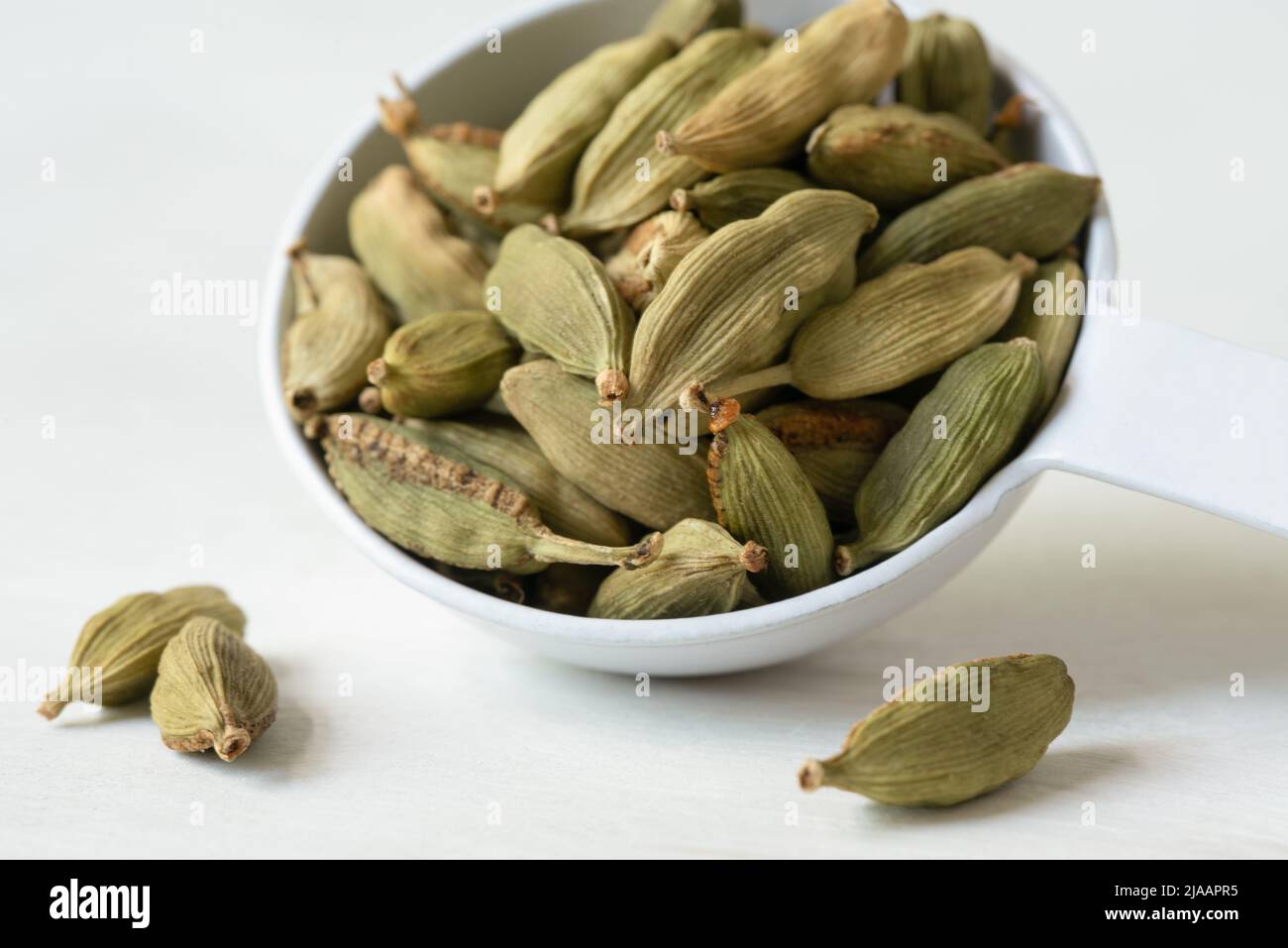 Green Cardamom Pods Spilled from a Teaspoon Stock Photo - Alamy