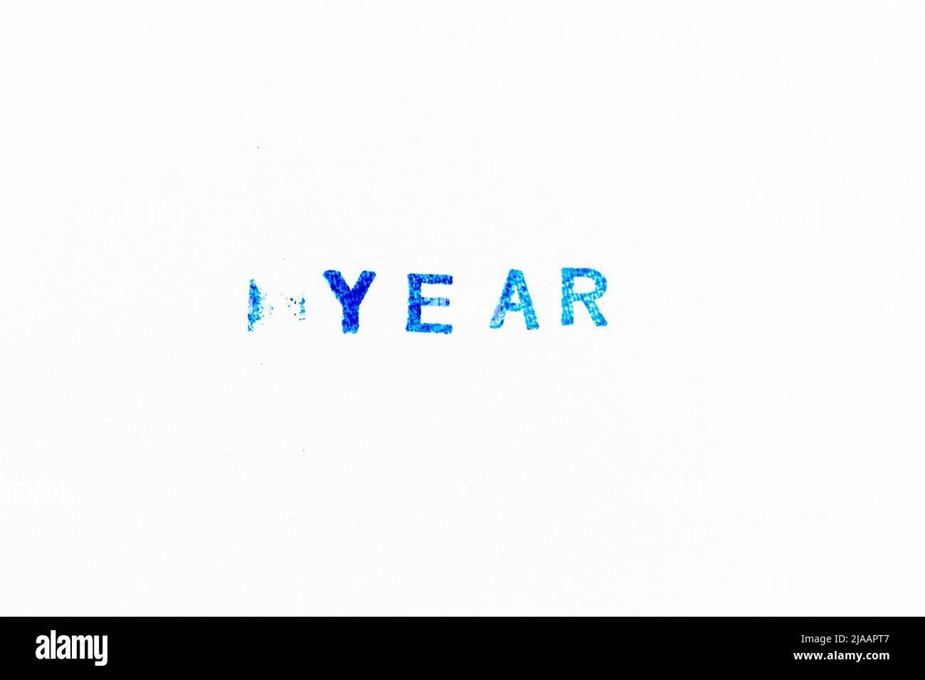 Blue color ink of rubber stamp in word year on white paper background ...