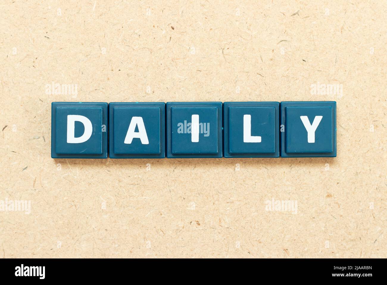 Tile alphabet letter in word daily on wood background Stock Photo - Alamy