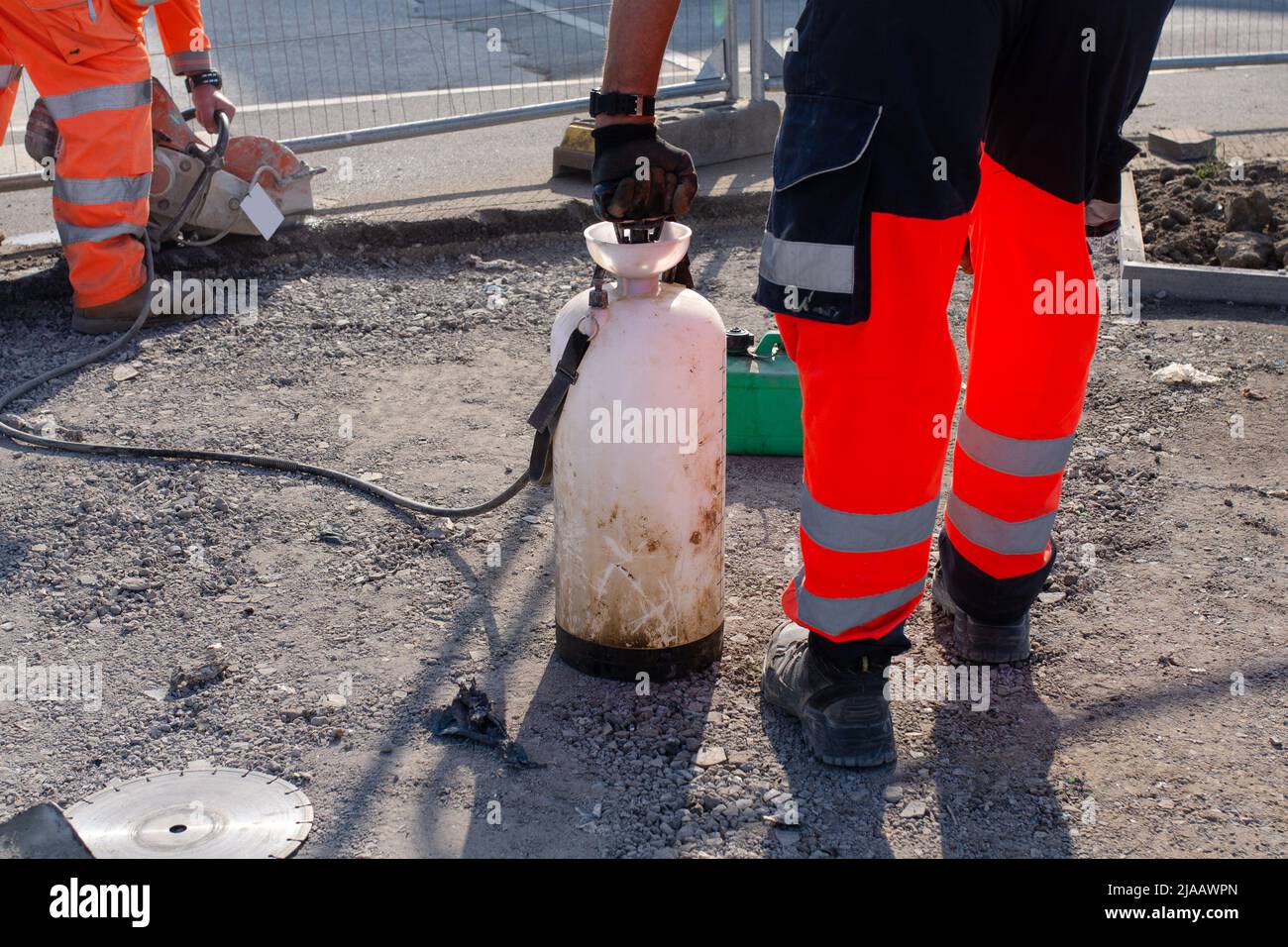 Groundworker cutting asphalt with petrol saw Stock Photo - Alamy