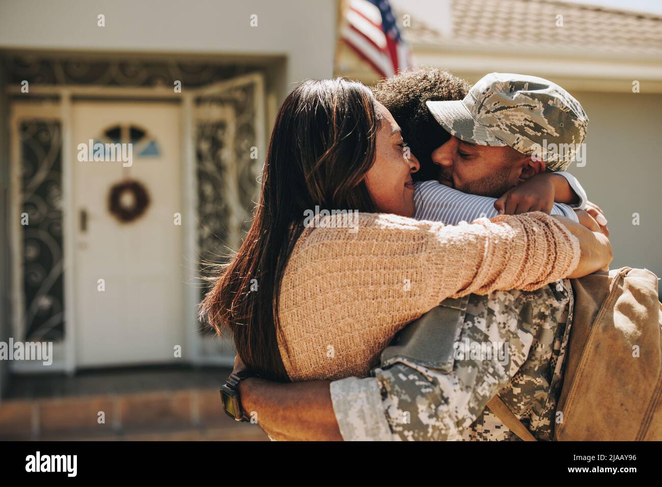 Military serviceman reuniting with his family after deployment. Soldier ...