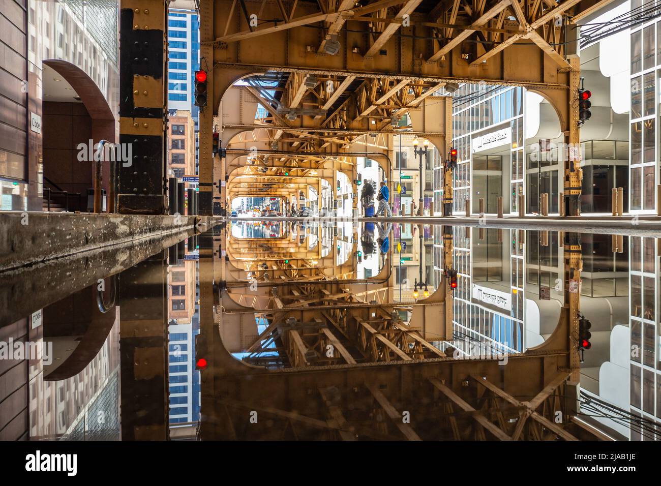 Overhead train lines on West Van Buren Street, Chicago, reflected in a ...