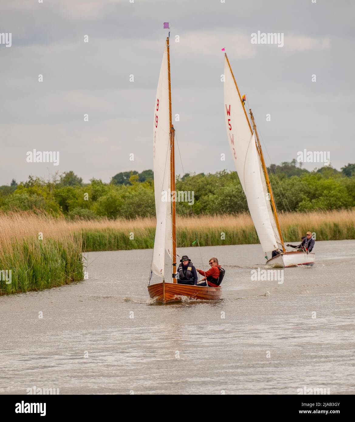 Horning, Norfolk, UK – May 28 2022. A Norfolk sailing boat leads a ...