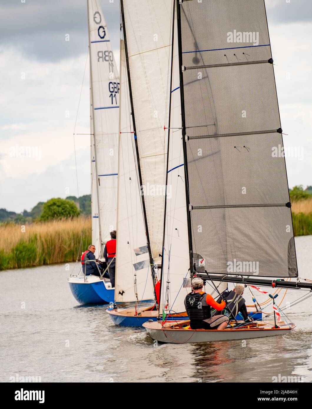 Horning, Norfolk, UK – May 28 2022. A line of various siling boats on ...
