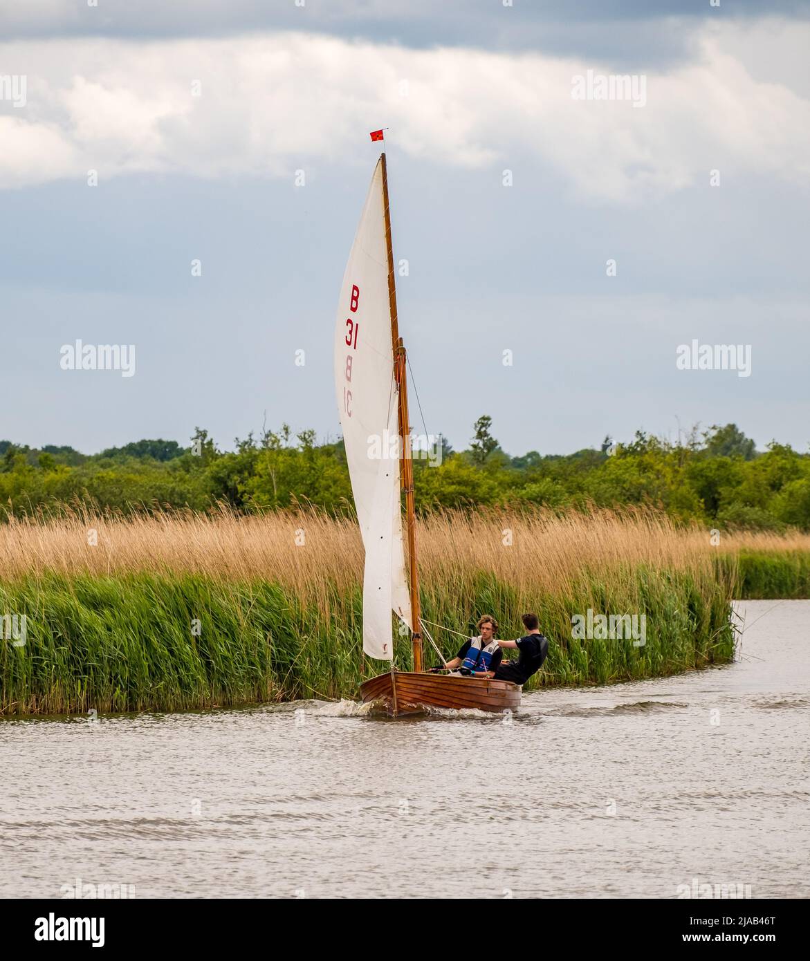 Horning, Norfolk, UK – May 28 2022. Two males racing a Norfolk Dinghy ...