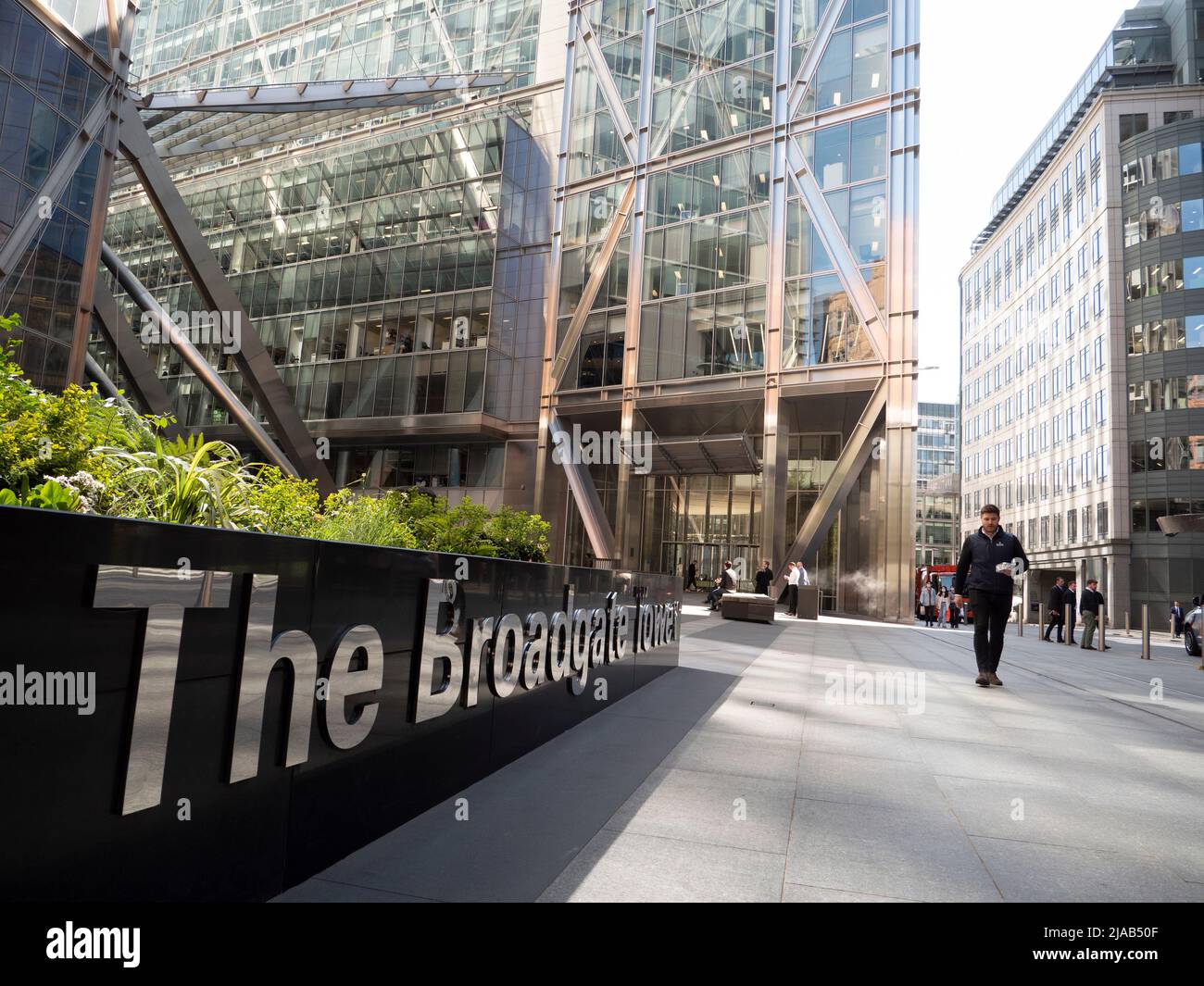 The Broadgate Tower London with commuters and pedestrians walking past ...