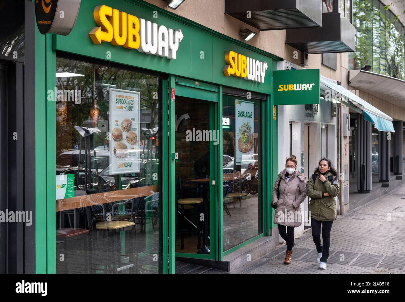 Pedestrians walk past the American sandwich fast food restaurant ...