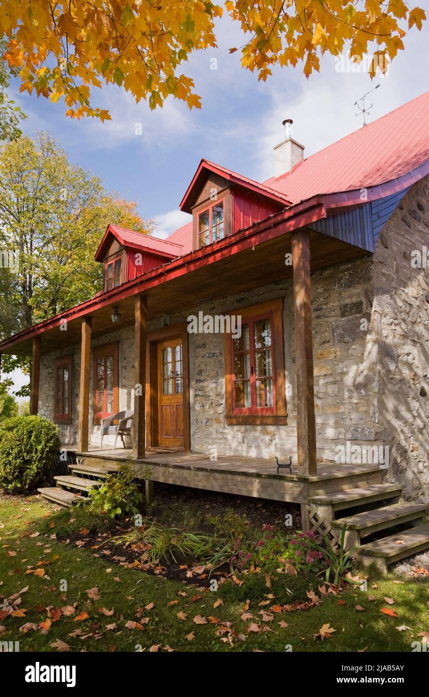 Old circa 1786 Canadiana cottage style fieldstone home facade with red ...