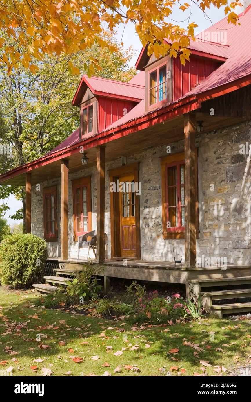 Old circa 1786 Canadiana cottage style fieldstone home facade with red ...
