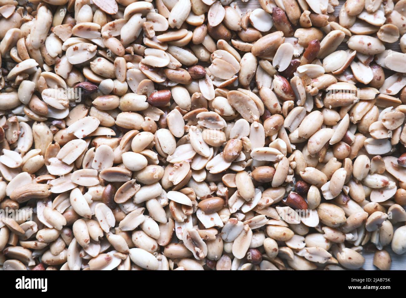 Processed pea nuts in a bowl on table top down Stock Photo - Alamy
