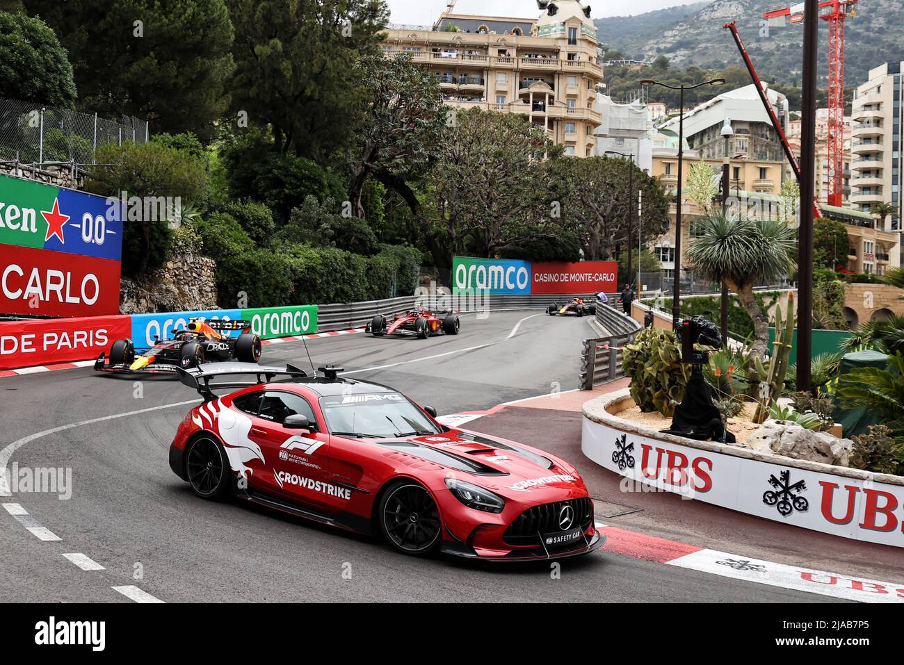 Sergio Perez (MEX) Red Bull Racing RB18 leads behind the Aston Martin ...