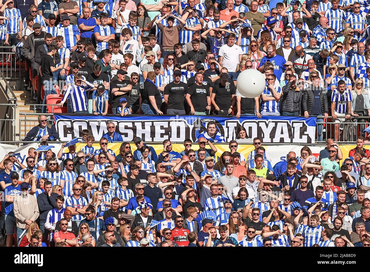 Huddersfield Town fans with a Cowshed Loyal banner Stock Photo - Alamy