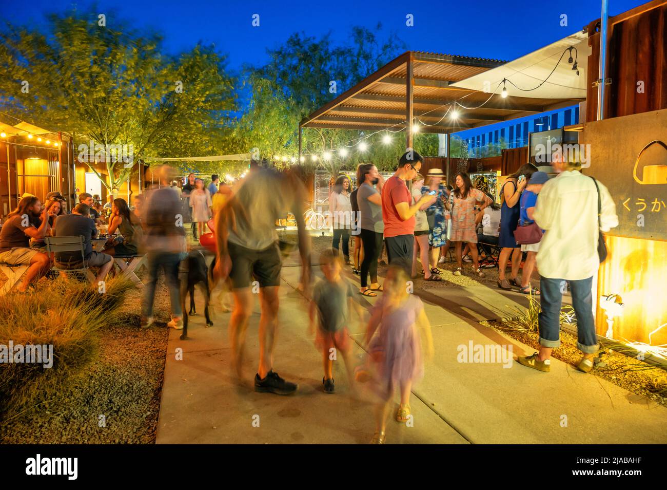 Families with children enjoy the outdoor summer night market in Tucson ...