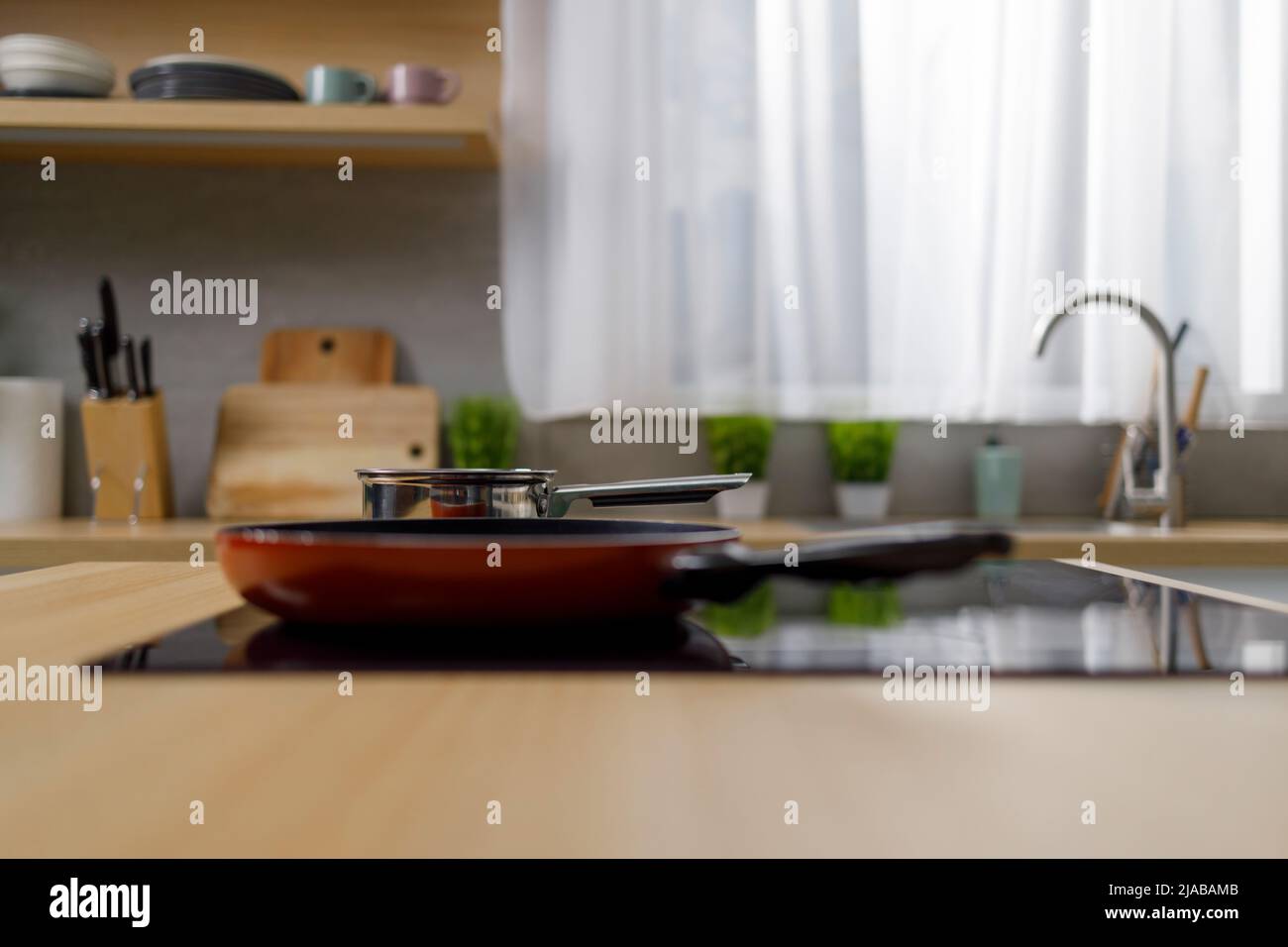 Modern induction hob and cookware in the kitchen Stock Photo - Alamy
