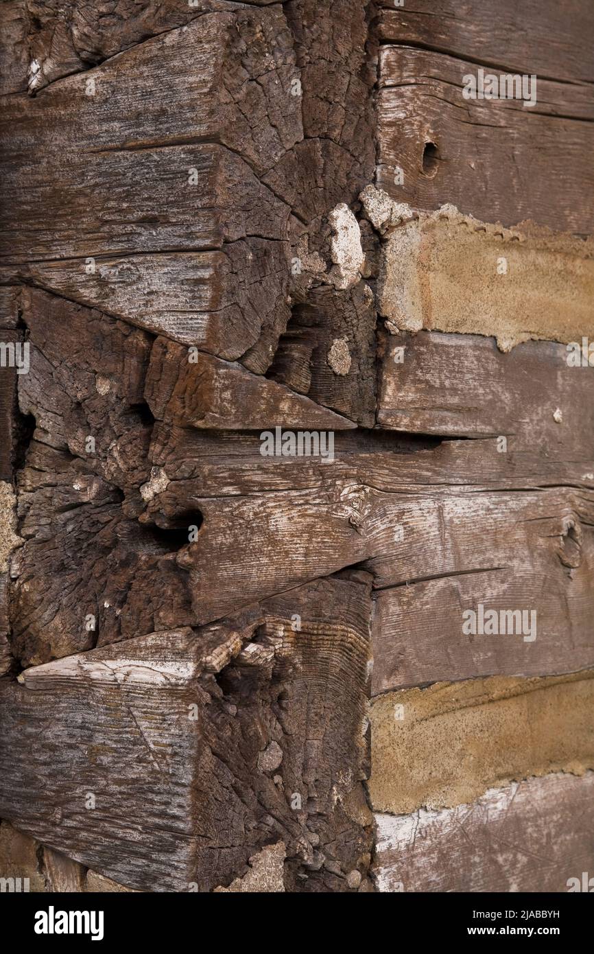 Close-up of stacked logs forming the outside corner walls on an old ...