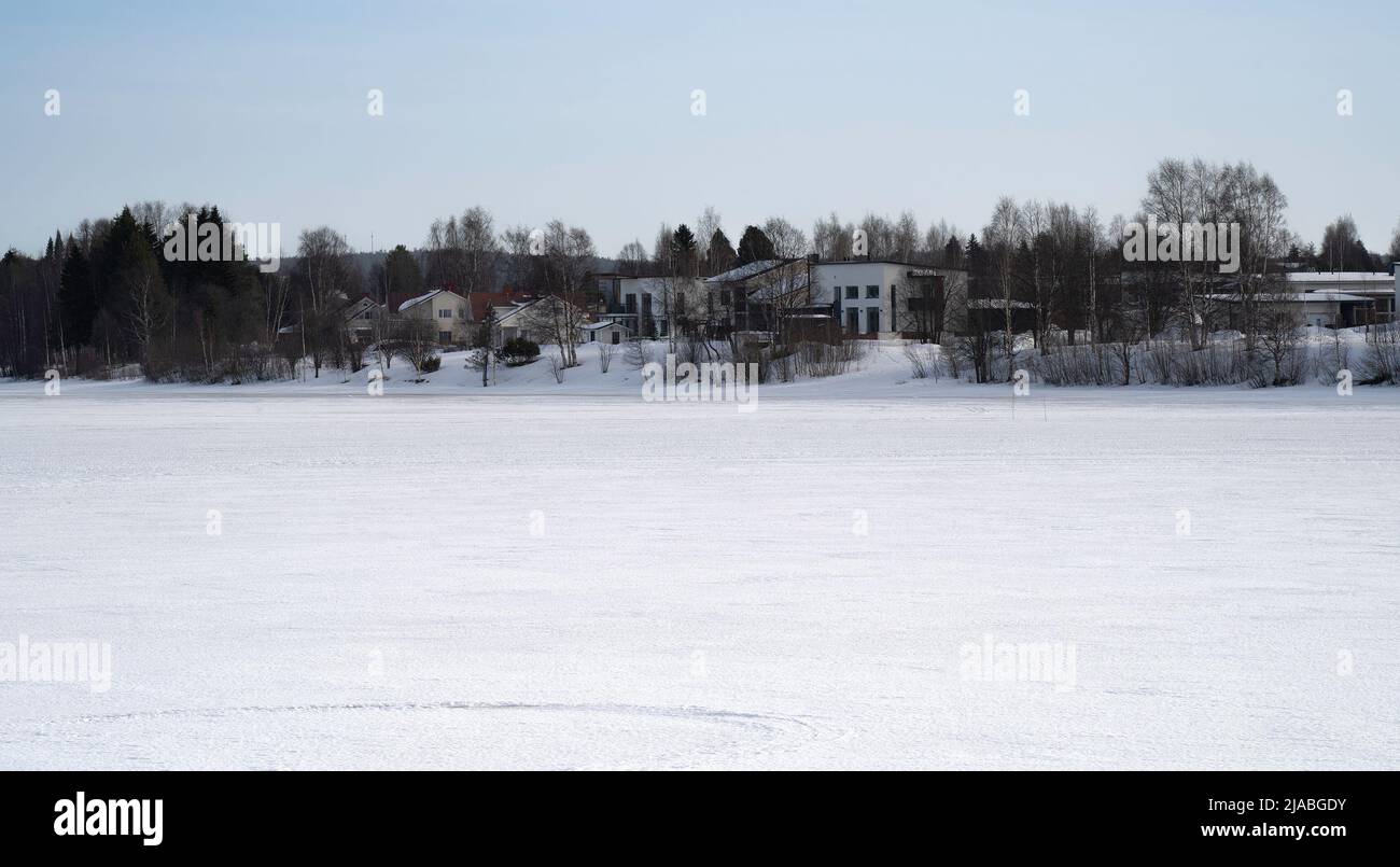 Houses on the bank of the frozen Kemijoki river, Rovaniemi, Finland ...