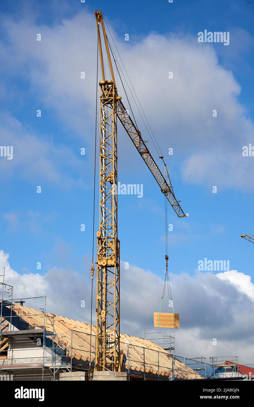 Crane working on construction site Stock Photo - Alamy