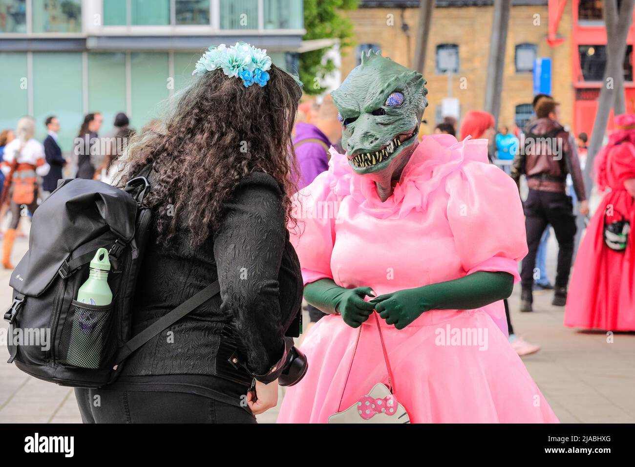 London, UK. 29th May, 2022. A cosplayer in reptile outfit chats to ...