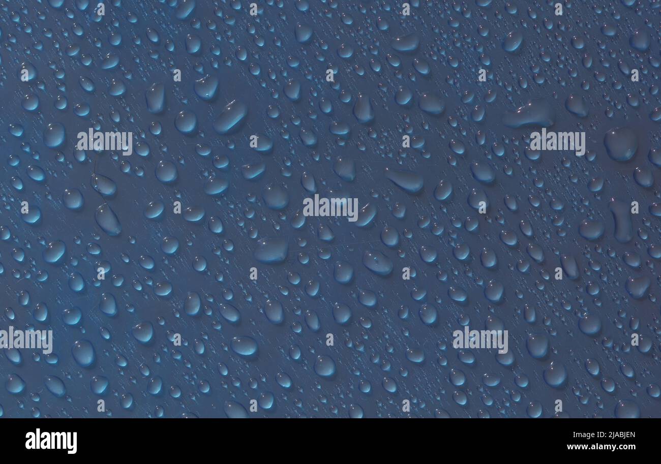 Abstract water drops texture. Wet raindrops on glass blue background ...