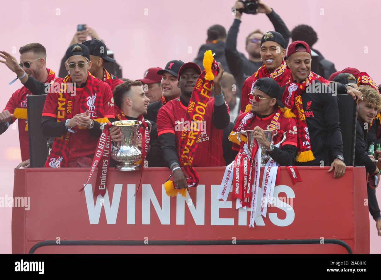 The Liverpool FC squad celebrate during the open top bus parade through ...