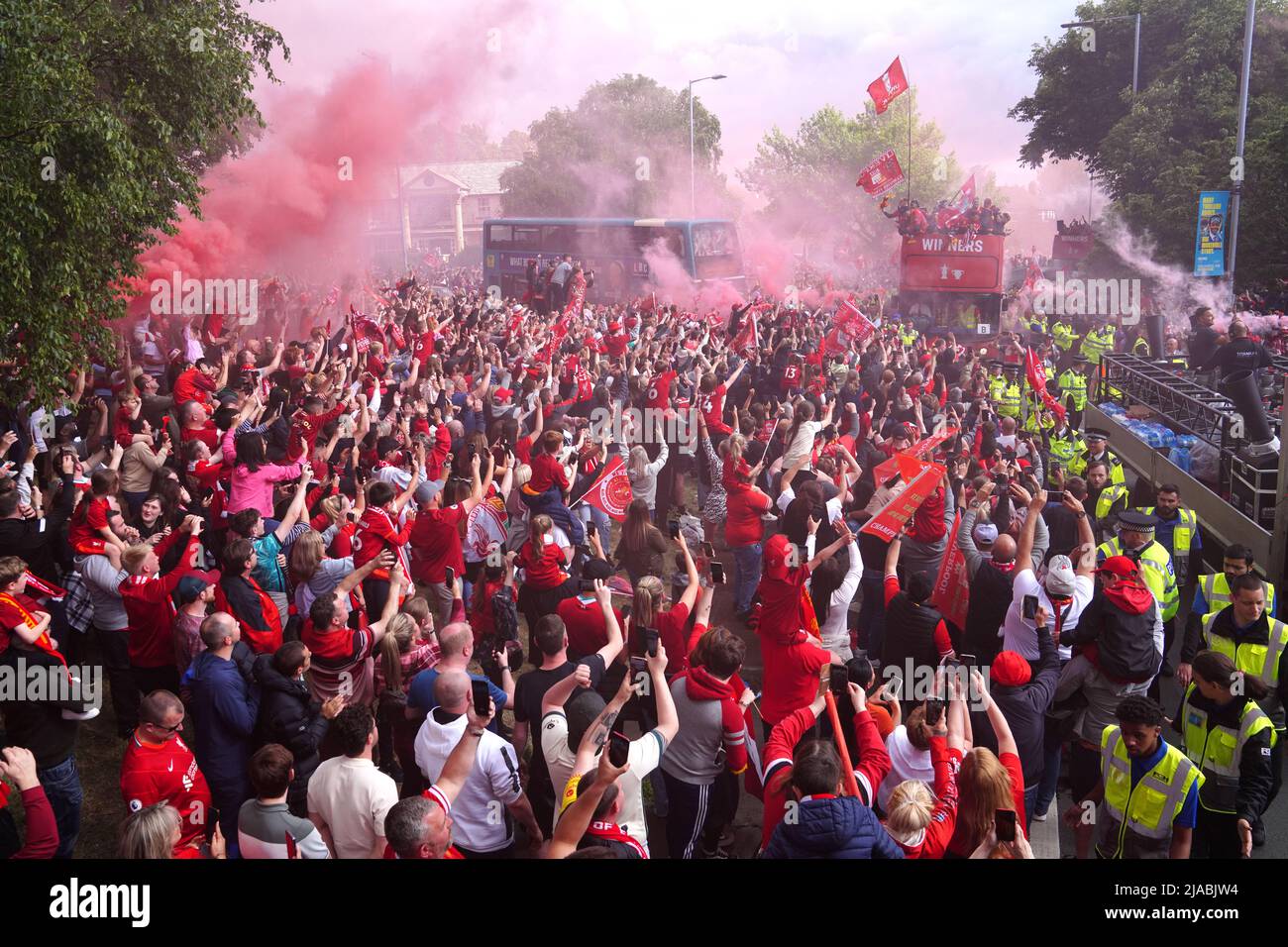 Liverpool fans react as the team busses pass by during the trophy ...