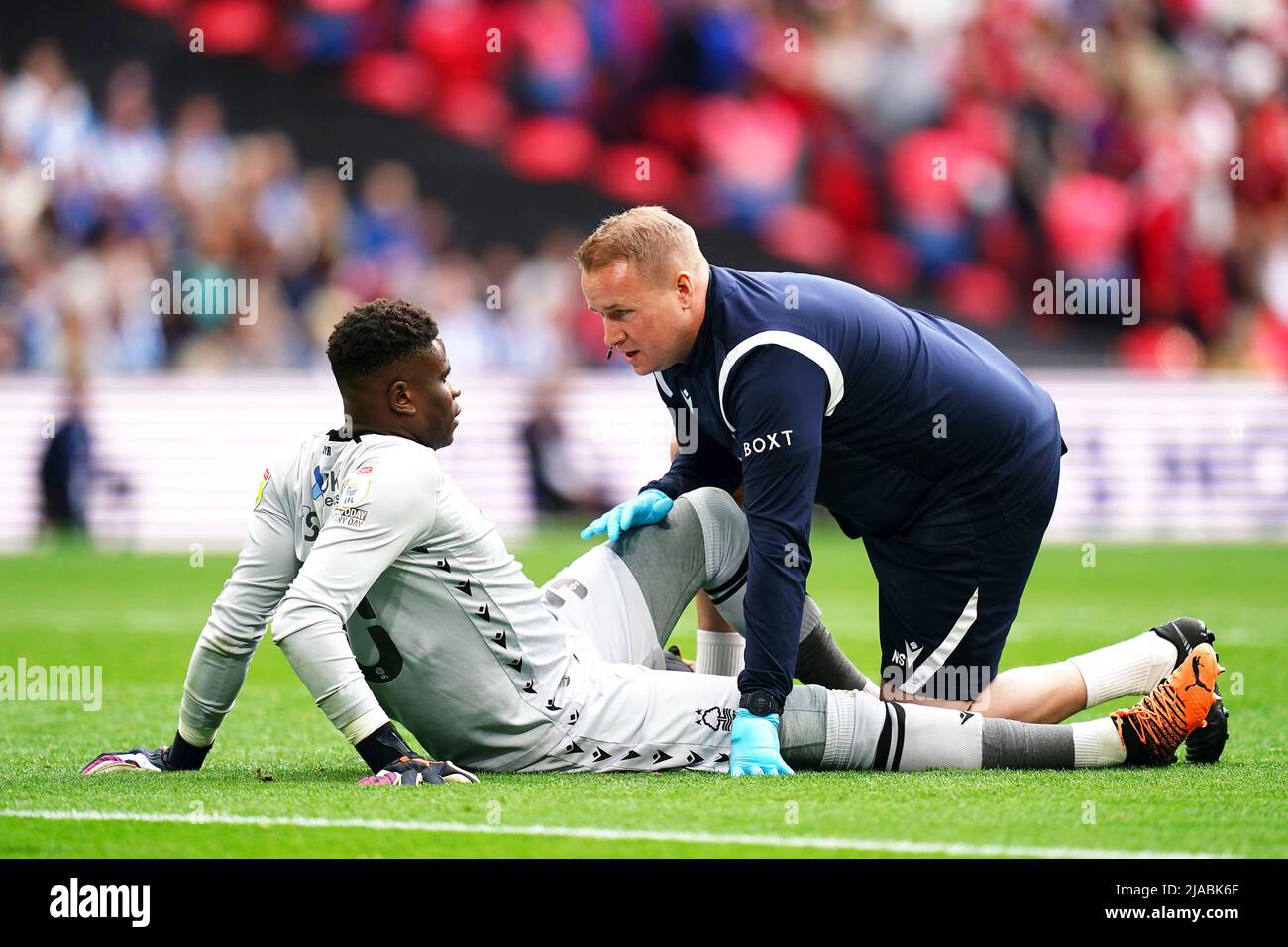 Nottingham Forest goalkeeper Brice Samba receives treatment during the ...