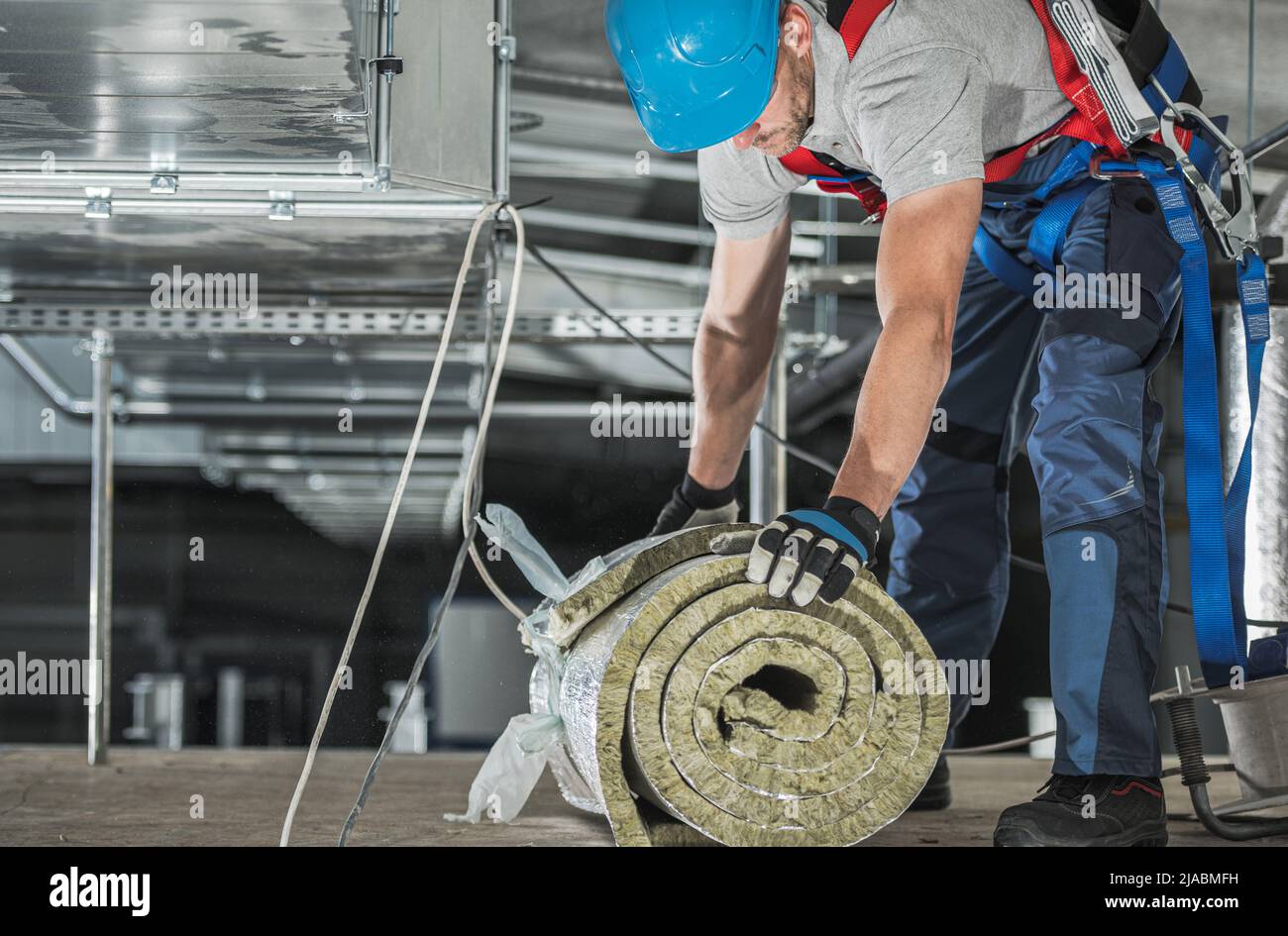 Commercial Warehouse Insulating Worker with Piece of Mineral Wool ...
