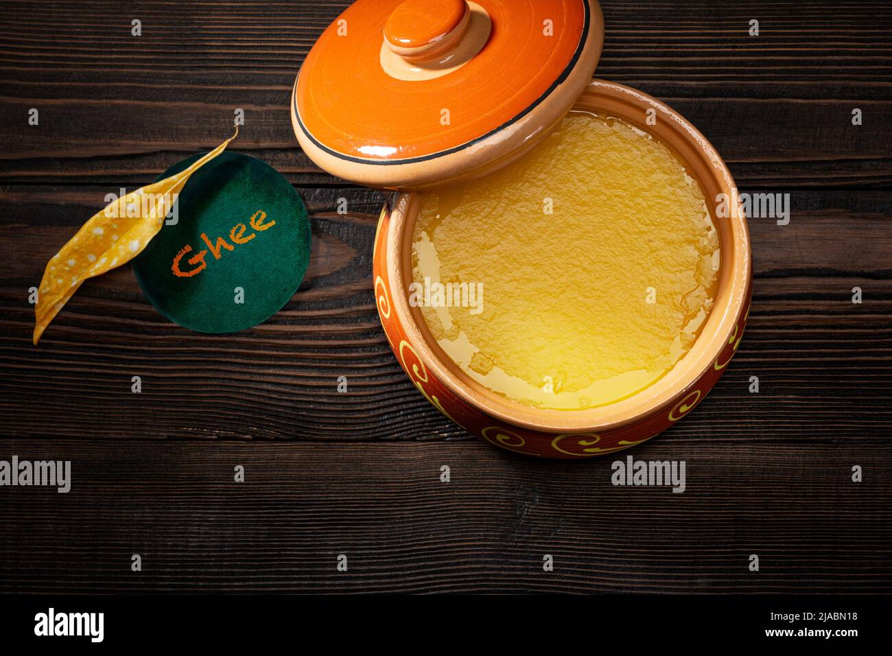 Homemade ghee in a ceramic pot and a sticker with the inscription with ...