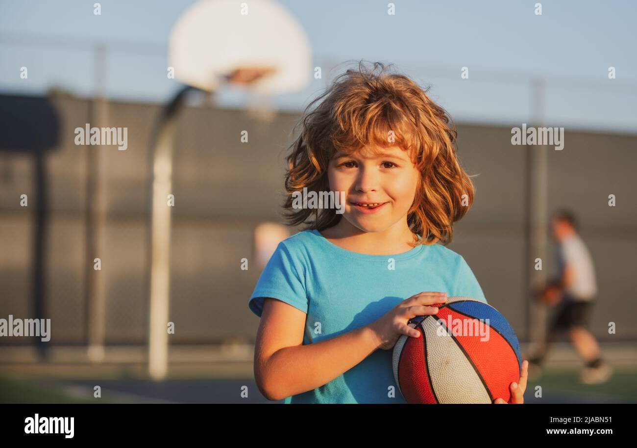 Basketball kids game. Portrait of cute little boy holding a basketball ...