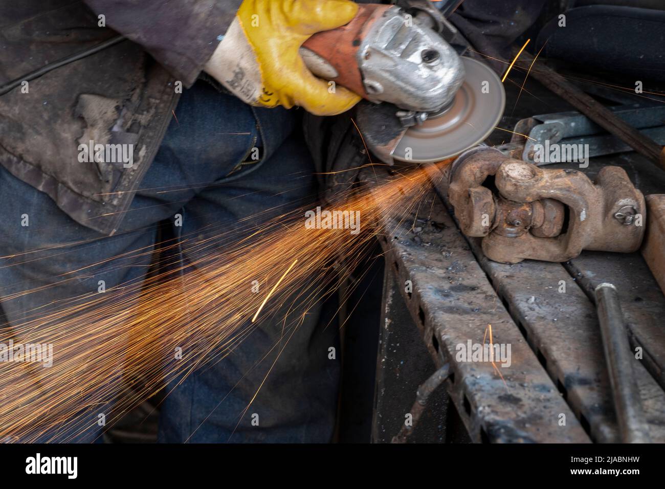 Worker cutting metal with grinder. Sparks while grinding iron Stock ...