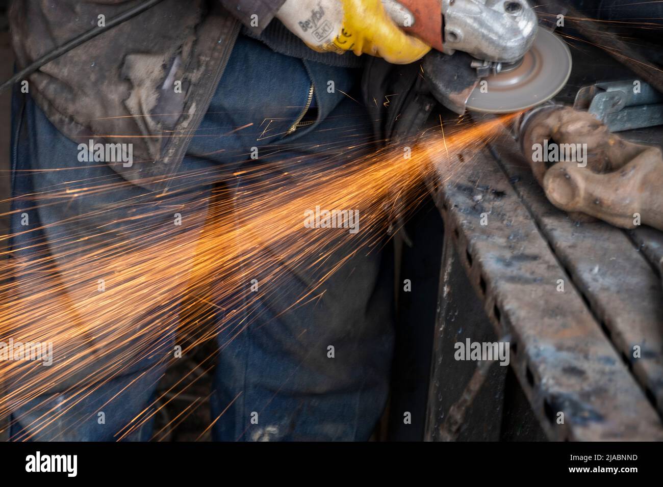 Worker cutting metal with grinder. Sparks while grinding iron Stock ...