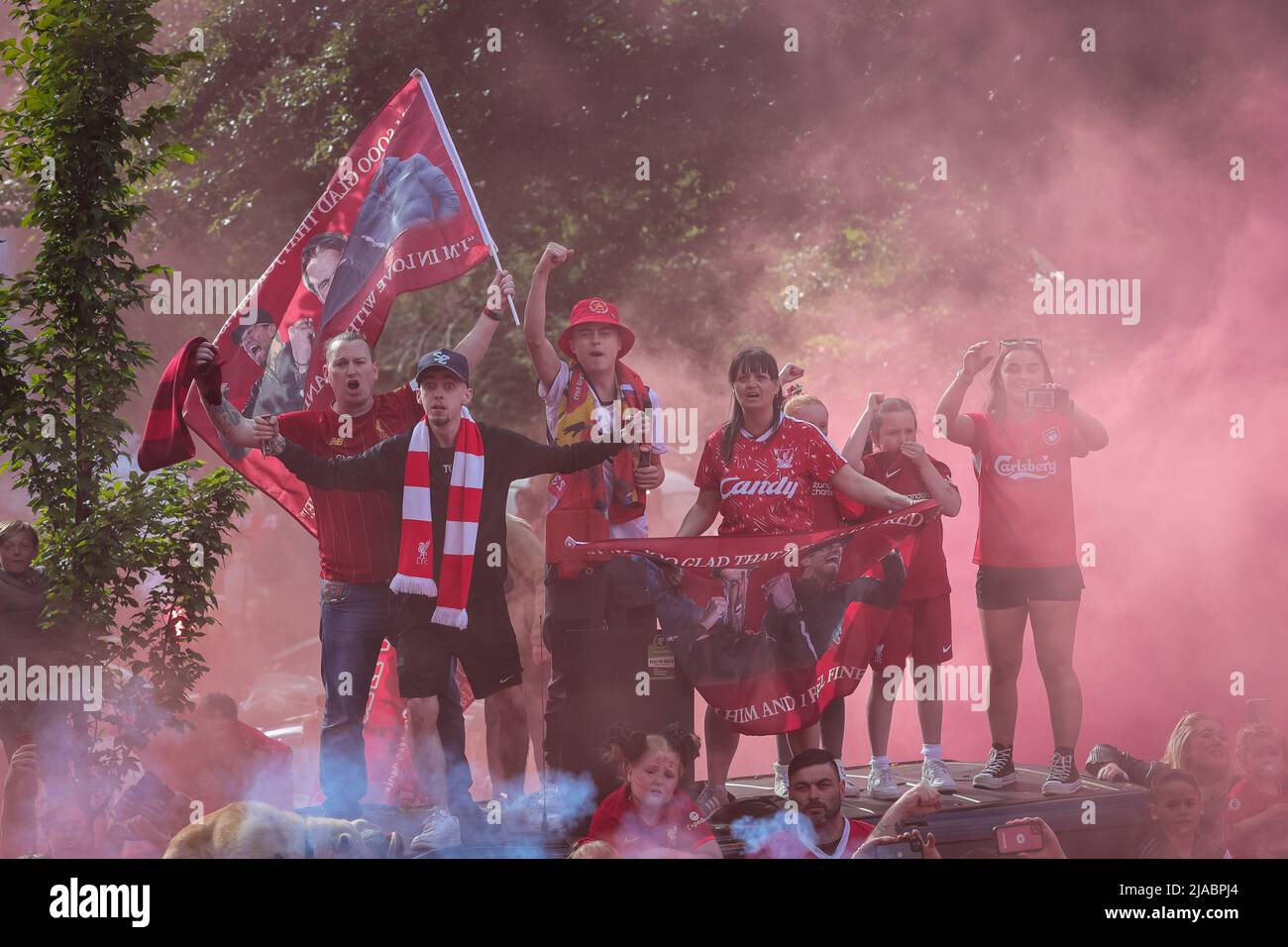 Supporters cheer on the Liverpool FC squad as they celebrate during the ...