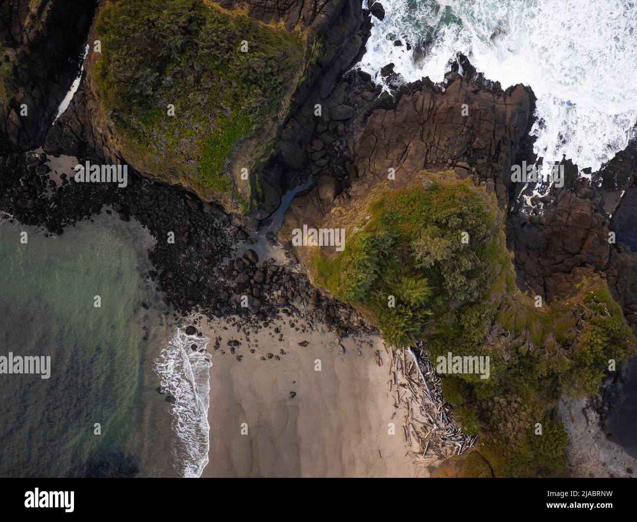 Shooting from the air. Rough rocky shore of the ocean, green moss ...
