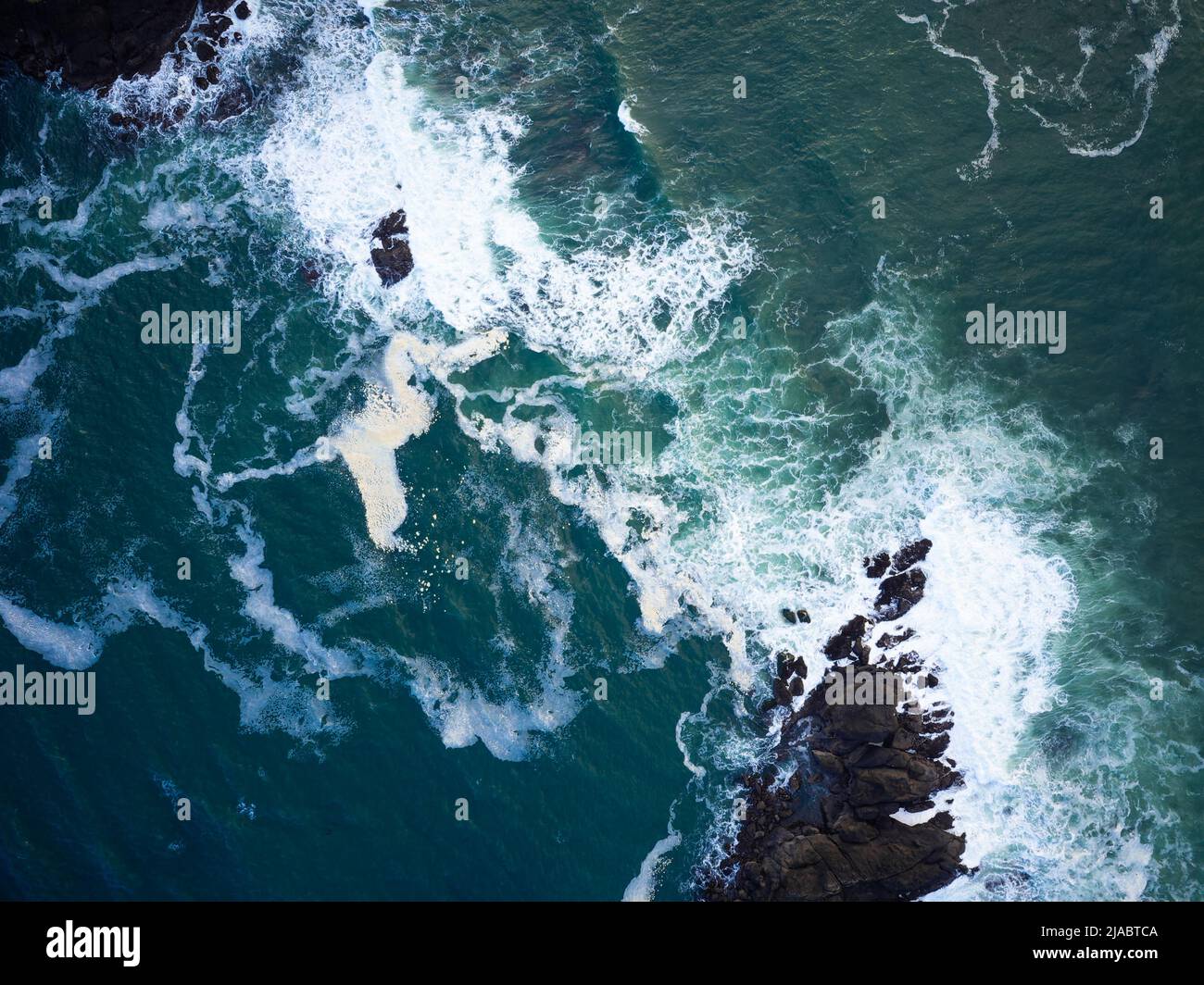 Dark blue foamy ocean water and rocky shore. Abstraction. Beauty of ...