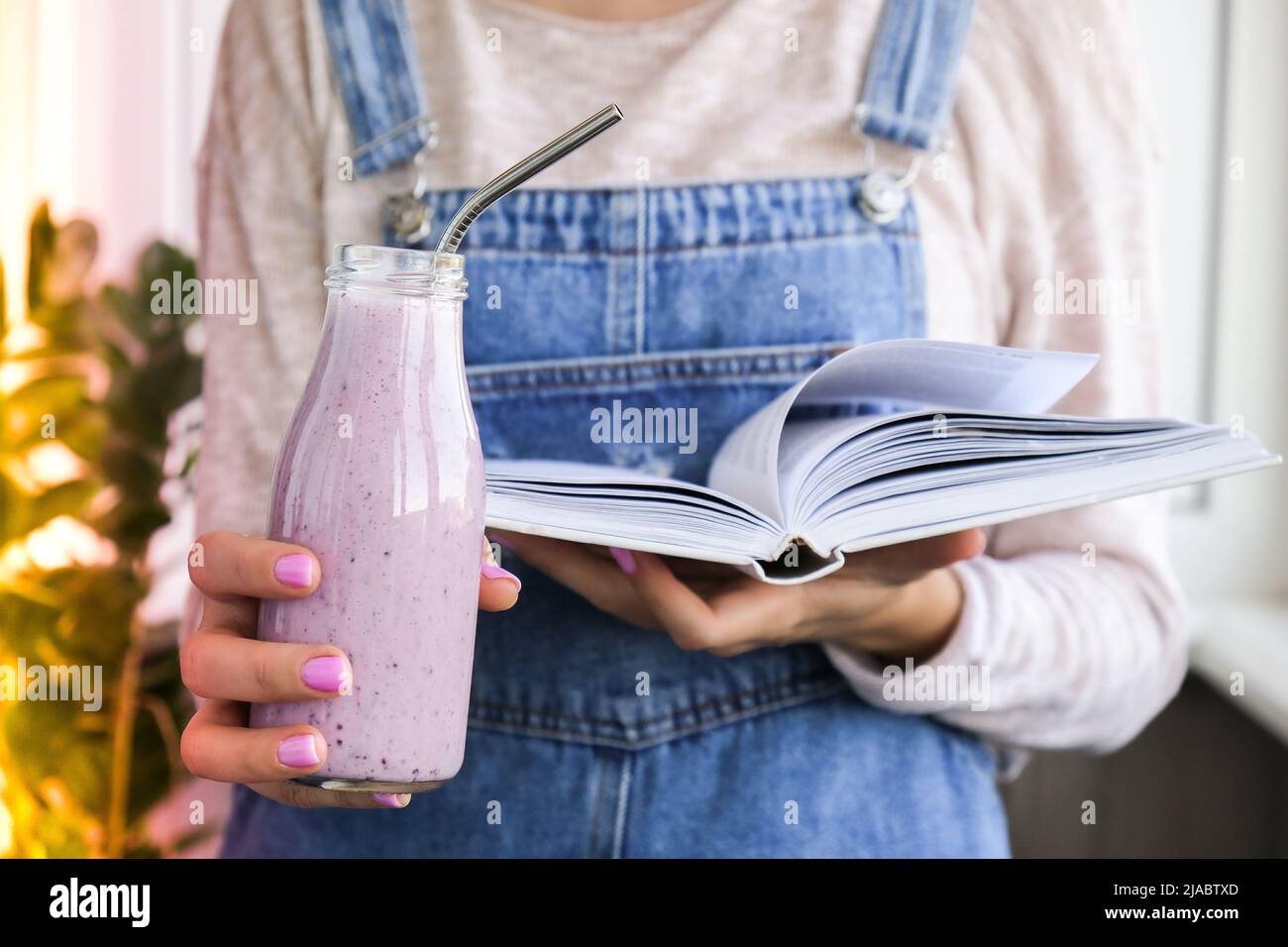Female hands holding Blueberry smoothie topped with blueberries. Woman ...
