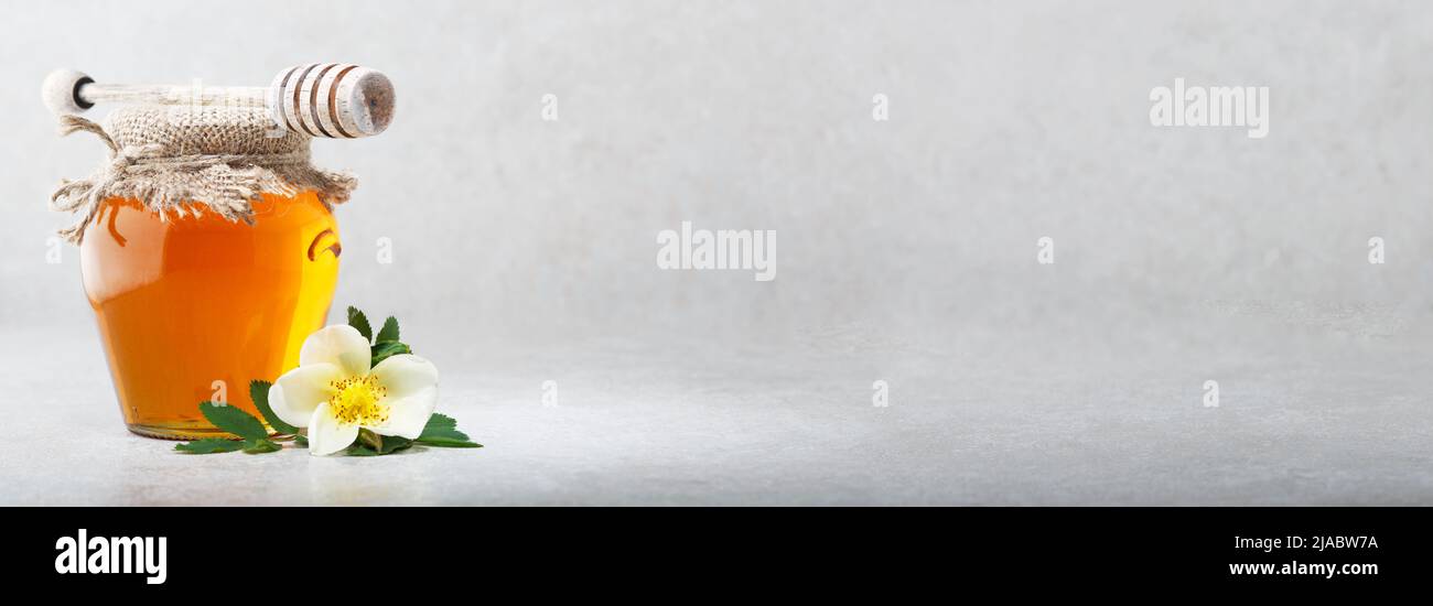 Honey background. Sweet honey in the glass jar. Light gray background ...