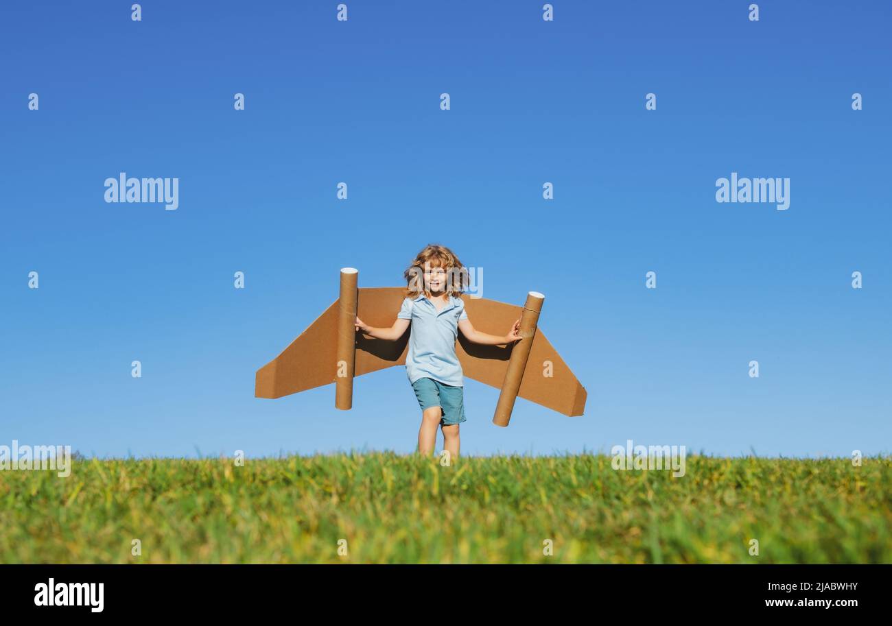 Boy child with wings at sky imagines a aviator pilot and dreams of ...